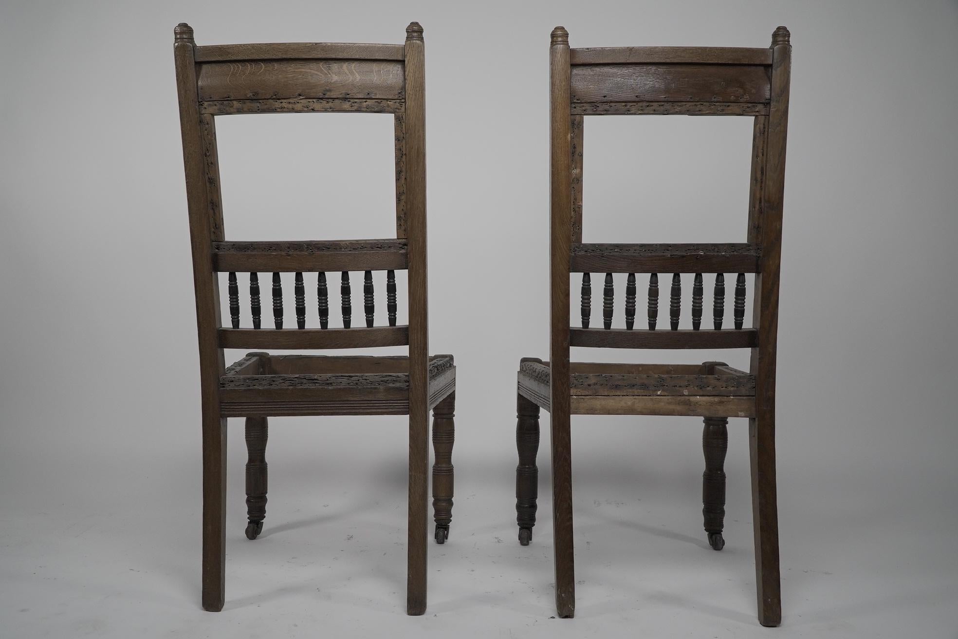 E W Godwin (attributed). A pair of oak dining chairs ready upholstery ...