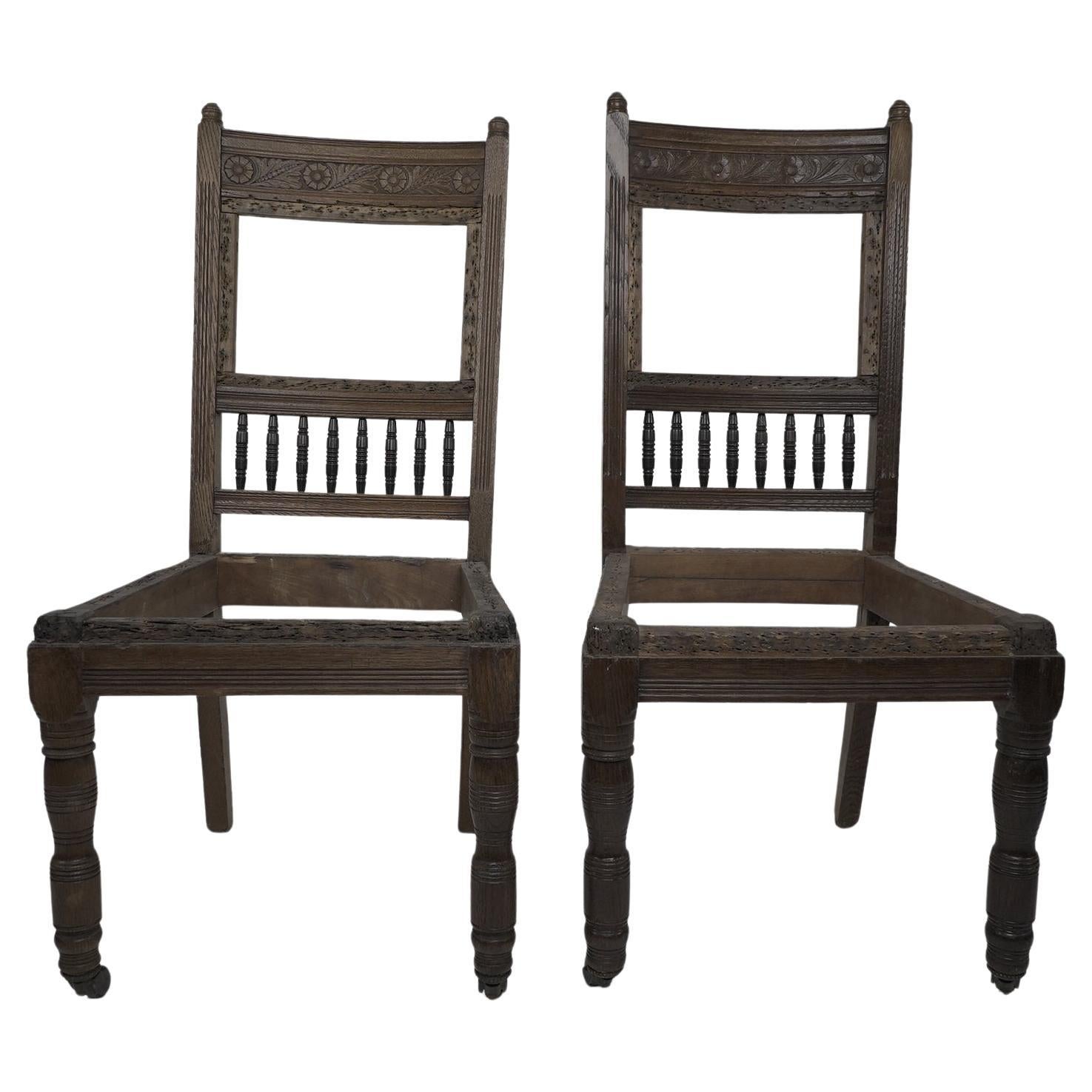 E W Godwin (attributed). A pair of oak dining chairs ready upholstery ...