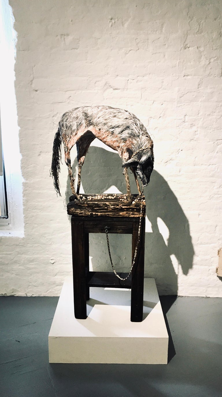 Elizabeth Jordan - Sculpture of wolf on wood platform with chain: ''Let ...