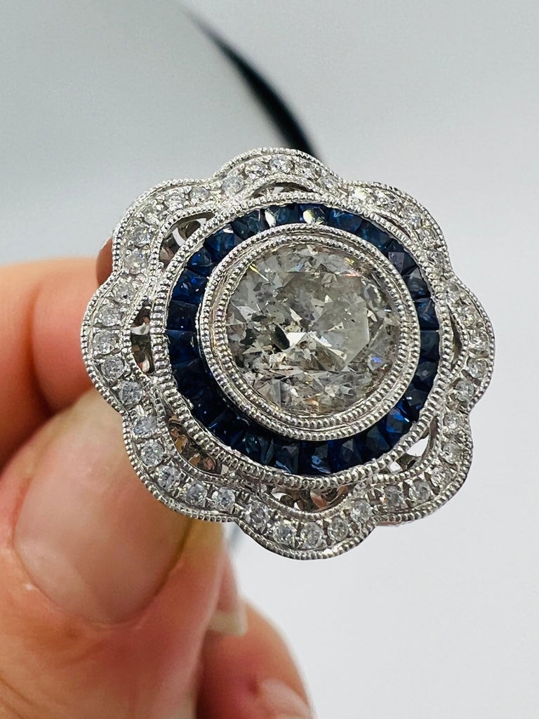engagement ring in platinum, solitaire surrounded by sapphires and ...