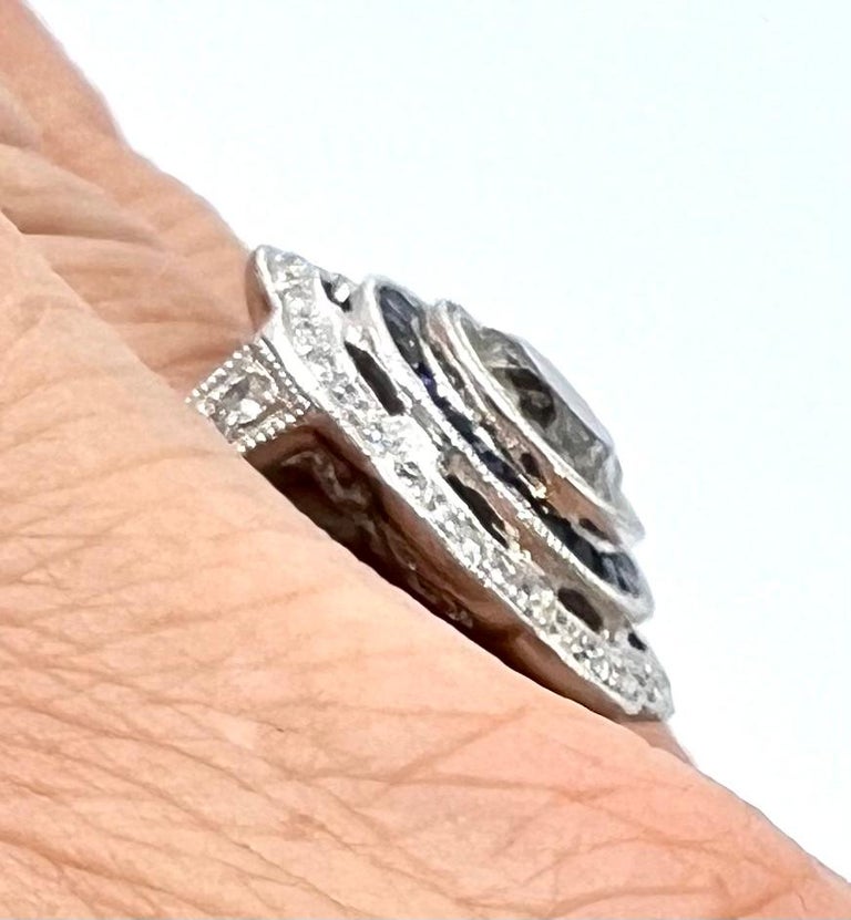engagement ring in platinum, solitaire surrounded by sapphires and ...