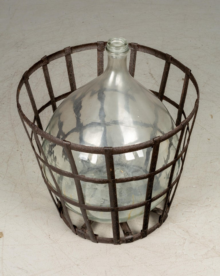French Glass Demijohn Bottle in Metal Basket at 1stDibs
