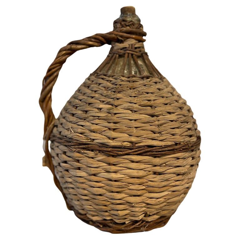 French Glass Demijohn Bottle in Woven Basket at 1stDibs