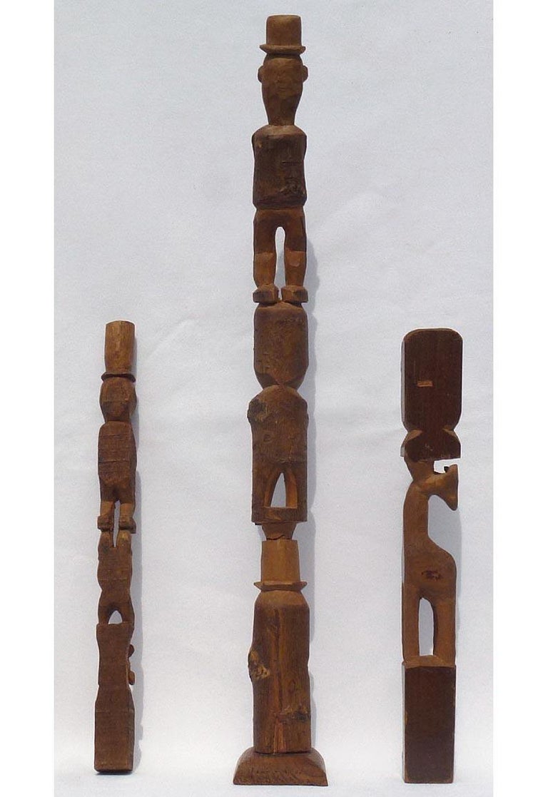 Group of three folky carved totems by the same maker. One is initialled ...