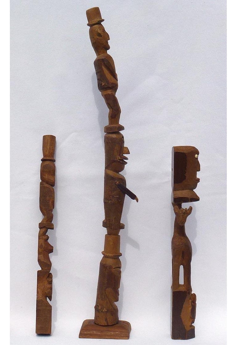 Group of three folky carved totems by the same maker. One is initialled ...