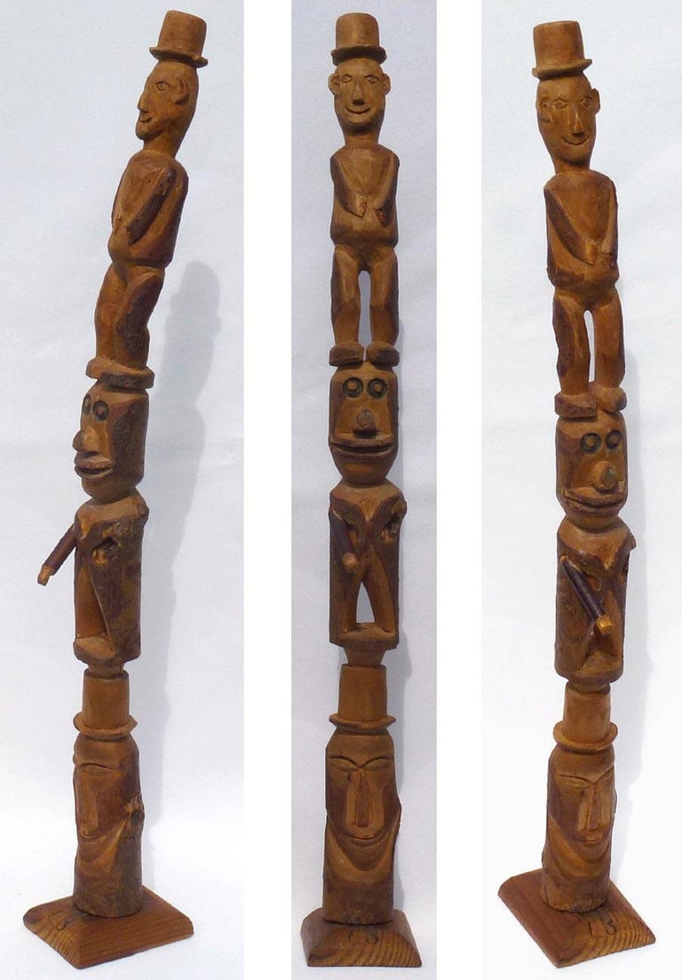Group of three folky carved totems by the same maker. One is initialled ...