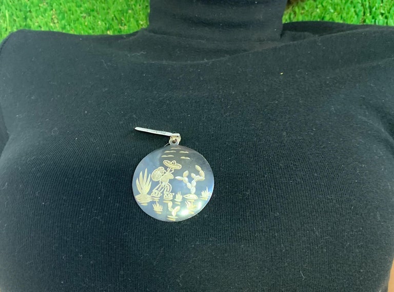 Hand Carved Silver Desert Worker Round Necklace Pendant For Sale at 1stDibs