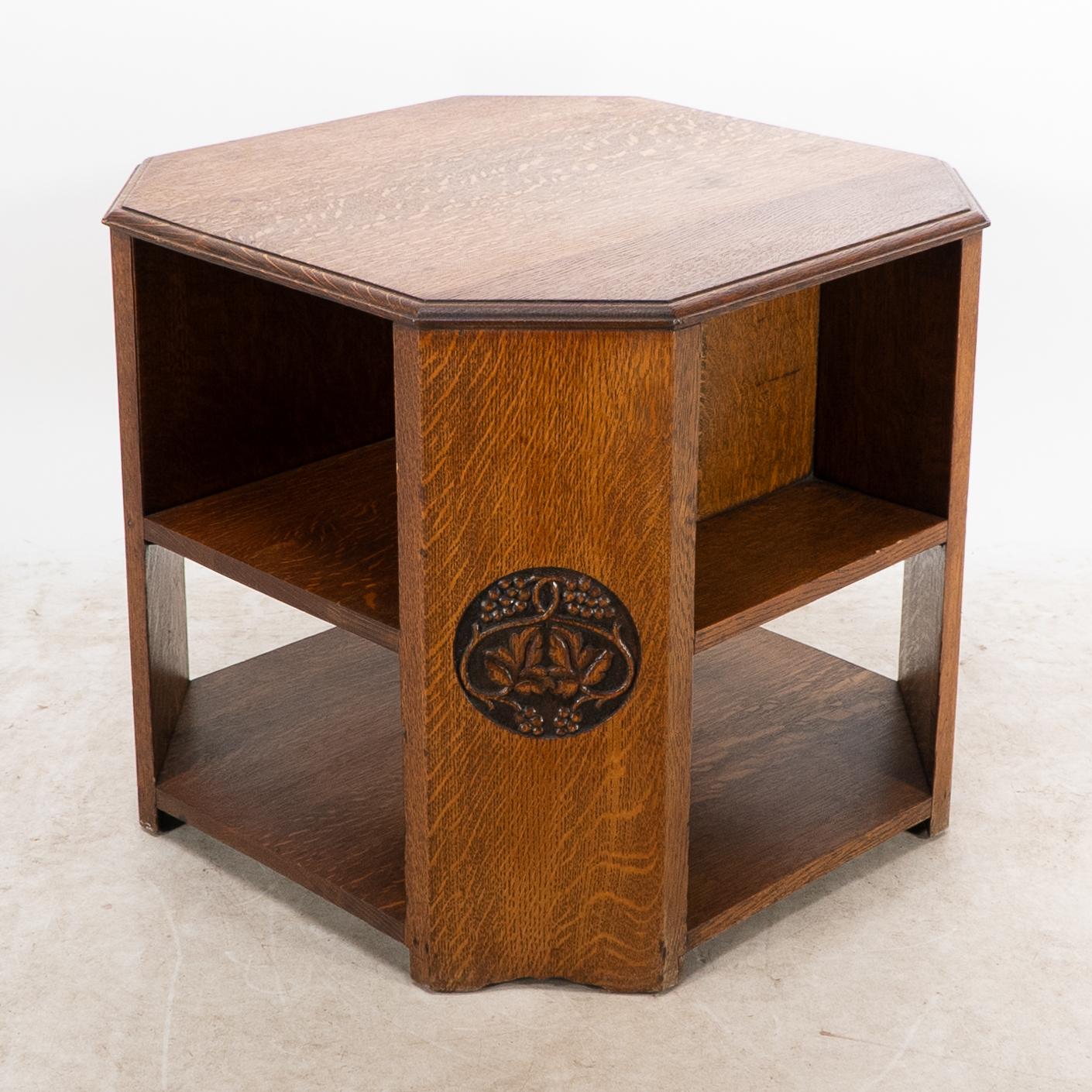 Heals. An Arts and Crafts octagonal oak bookcase/side table with carved ...