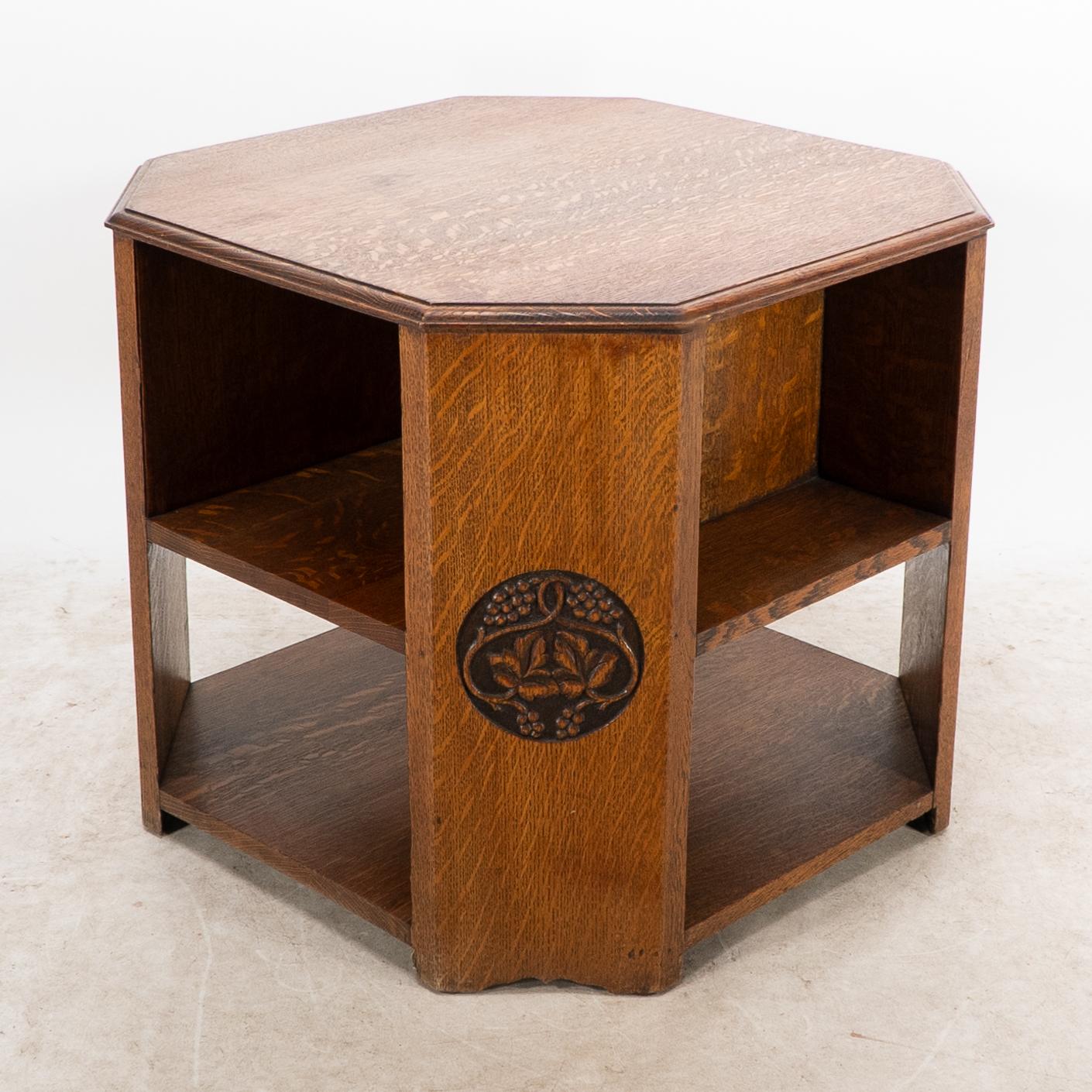 Heals. An Arts and Crafts octagonal oak bookcase/side table with carved ...