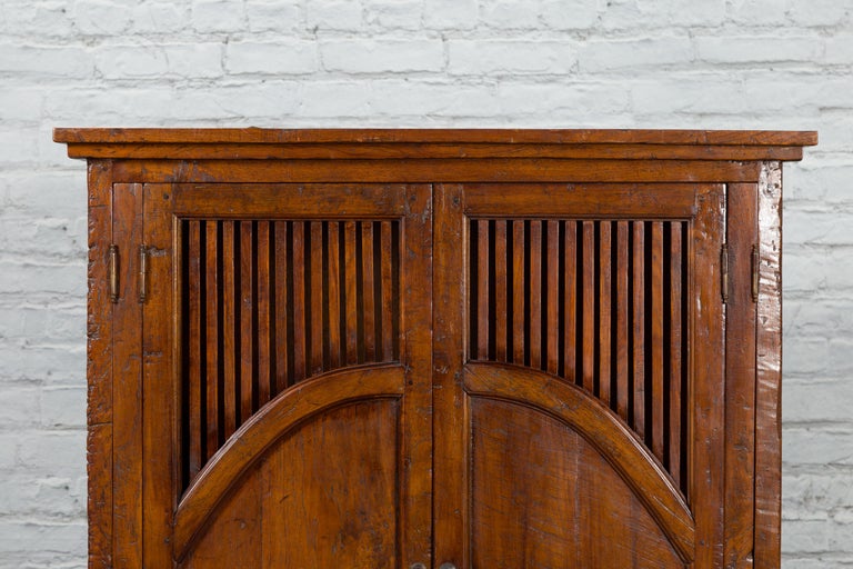 Javanese Antique Teak Armoire with Slatted Motifs, Tapered Feet and ...