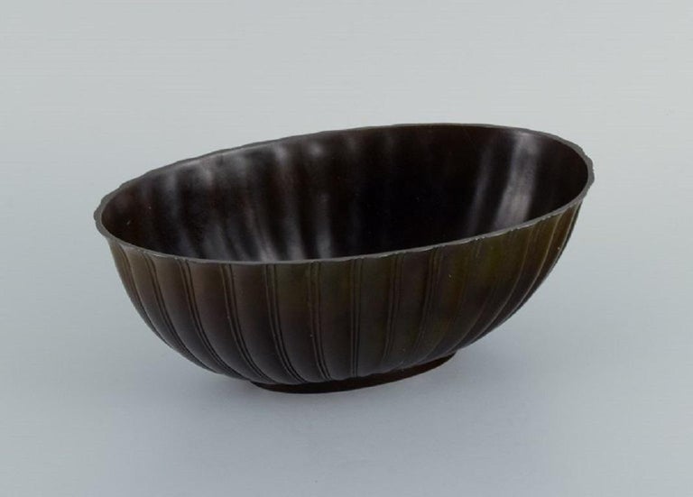 Just Andersen. Jardiniere of patinated disco metal with grooved body ...