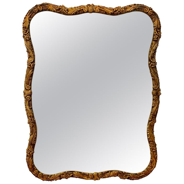 Large Carved and Curved Gold Giltwood Wall Mirror For Sale at 1stDibs