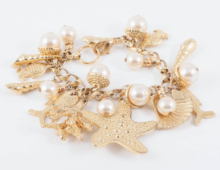 Large gilt metal and paste pearl 'seashell' charm bracelet, USA, 1960s ...