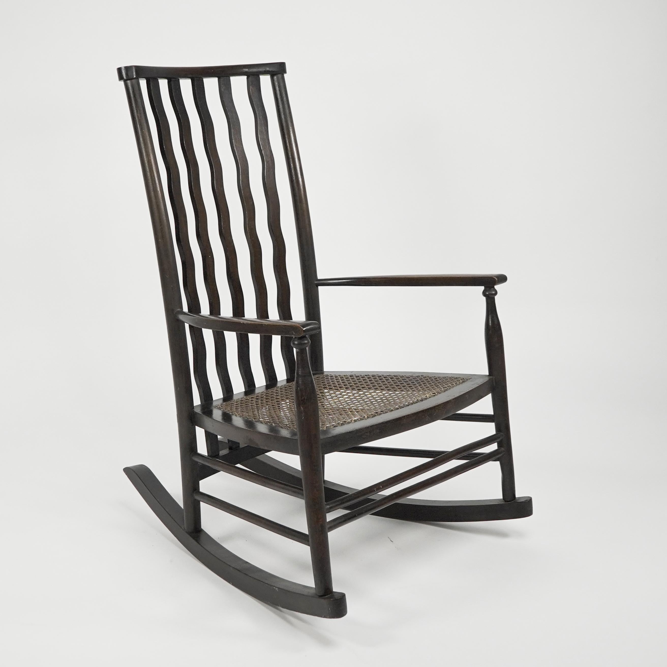 Liberty and Co. A litte beech stained and original cane seated rocking ...