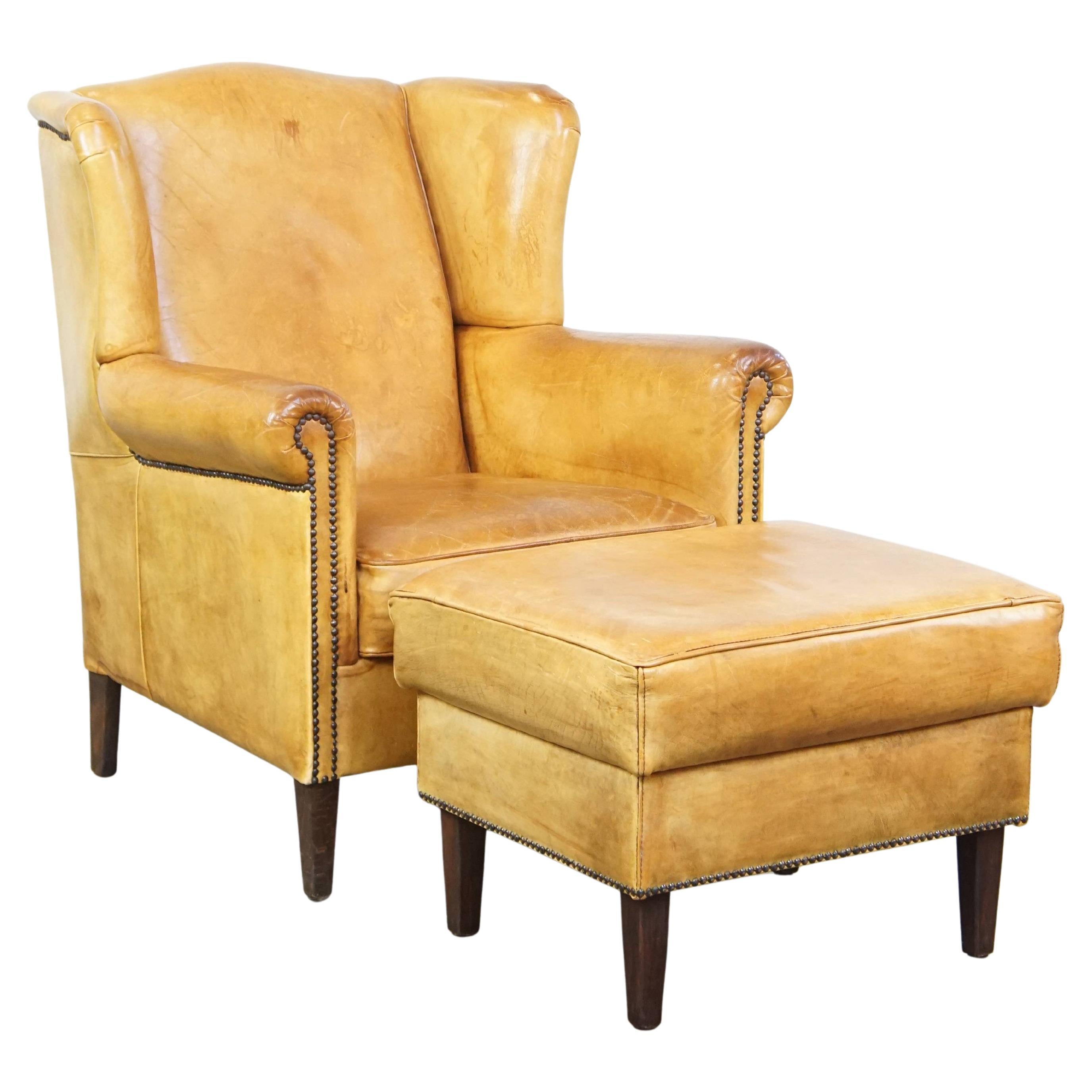 Light-colored vintage English-style leather wingback chair + ottoman ...