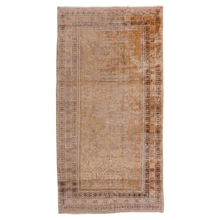 Lightly Distressed Gold Antique Khotan Rug, circa 1910s For Sale at 1stDibs