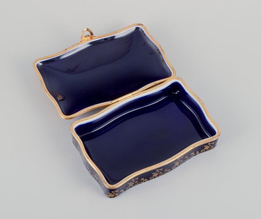 Limoges, France. Two porcelain boxes with lid decorated with 22-karat ...