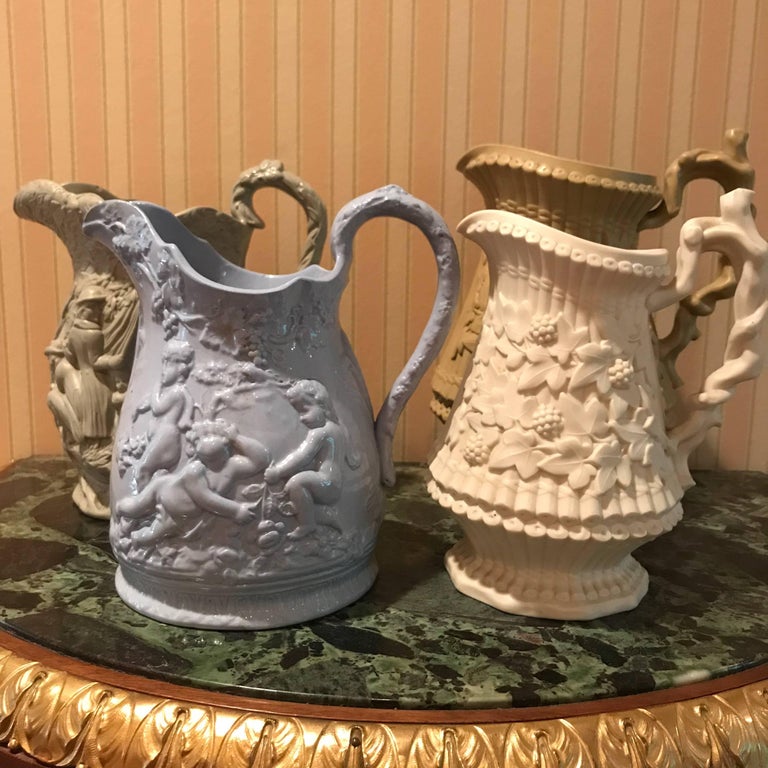 Lot of Four Stoneware and Ceramic Relief Pitchers at 1stDibs