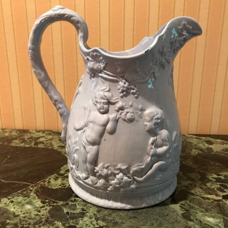Lot of Four Stoneware and Ceramic Relief Pitchers at 1stDibs