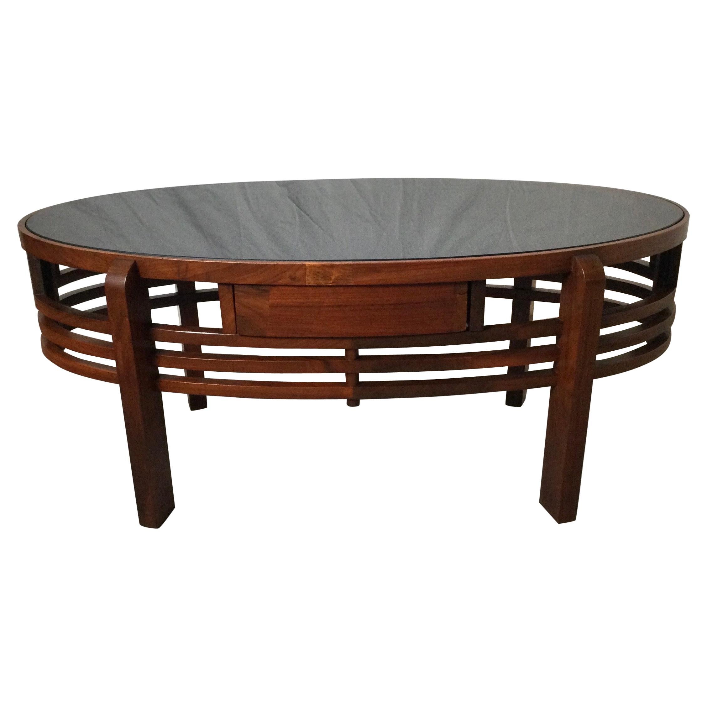 Mid 20th Century Oval Walnut Cocktail Table with Black Glass Top at 1stDibs