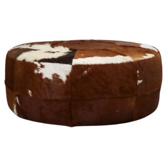 Mid-Century Inspired Brown and White Cowhide Ottoman For Sale at 1stDibs