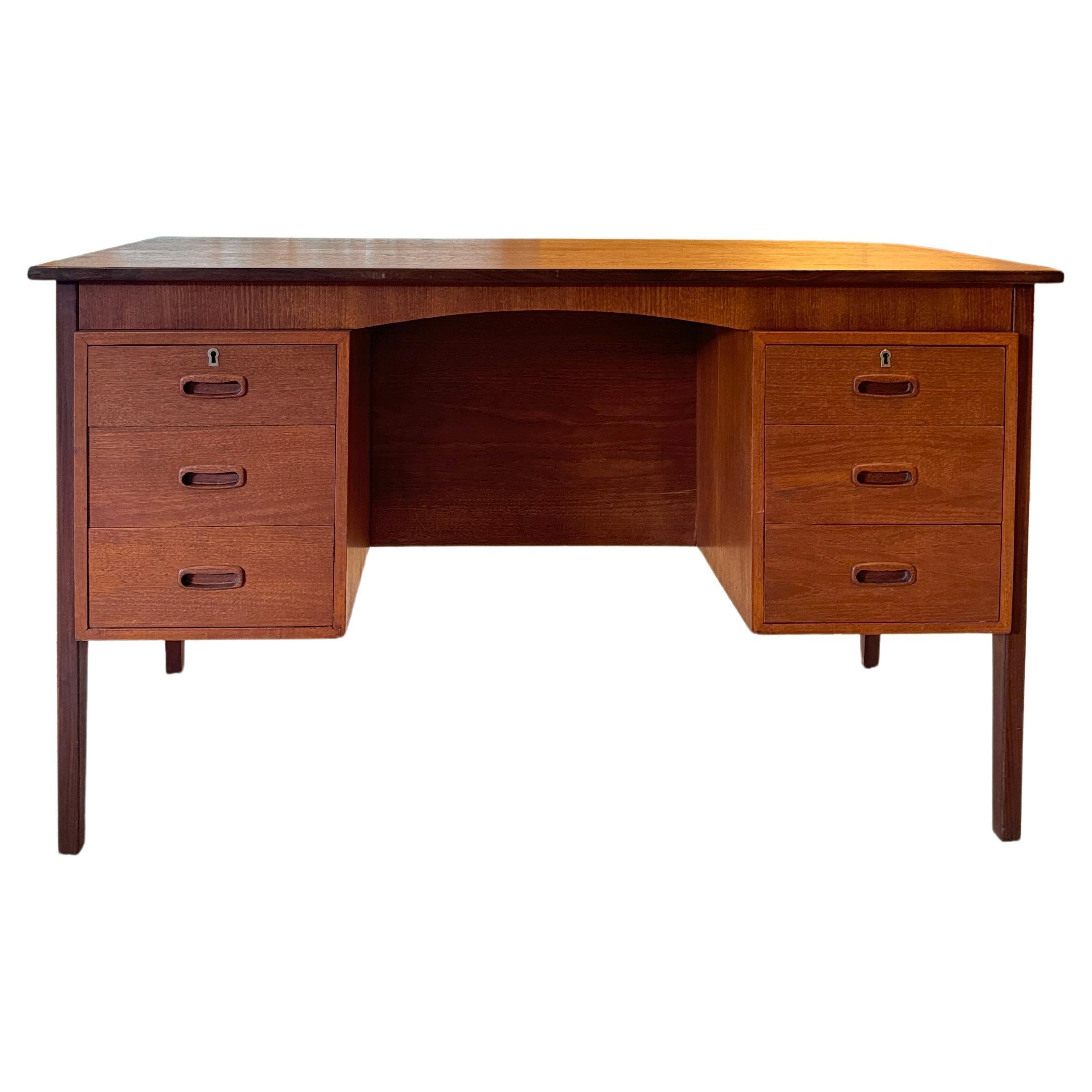 Mid century modern front facing desk made of teak, circa 1960s at 1stDibs