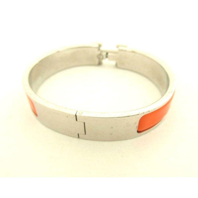 Orange metal Hermes Clic Clac bangle with Palladium hardware and signature For Sale at 1stDibs