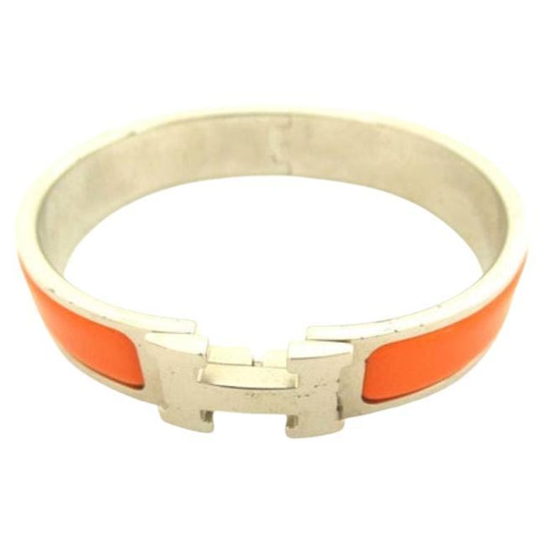 Orange metal Hermes Clic Clac bangle with Palladium hardware and signature For Sale at 1stDibs