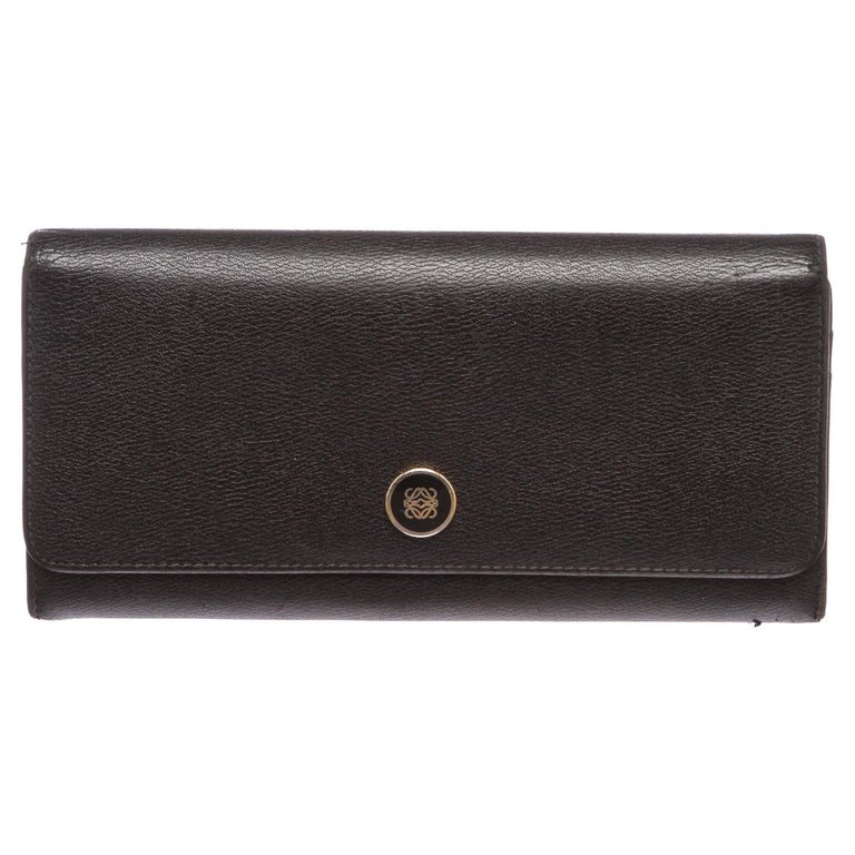 Overall flap snap closure with embellishment. Interior is leather and ...