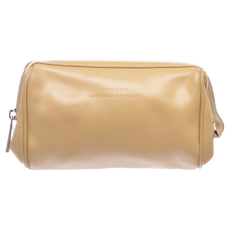 Overall zipper closure. Interior is fabric lined with one side slip ...