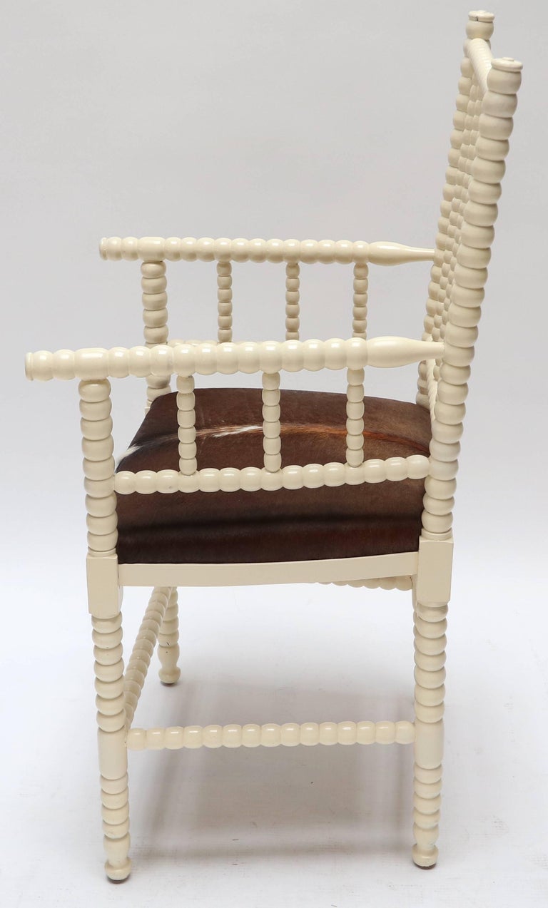 Pair of 1940s Ivory Spool Armchairs in Brown Cow Hide For Sale at 1stDibs