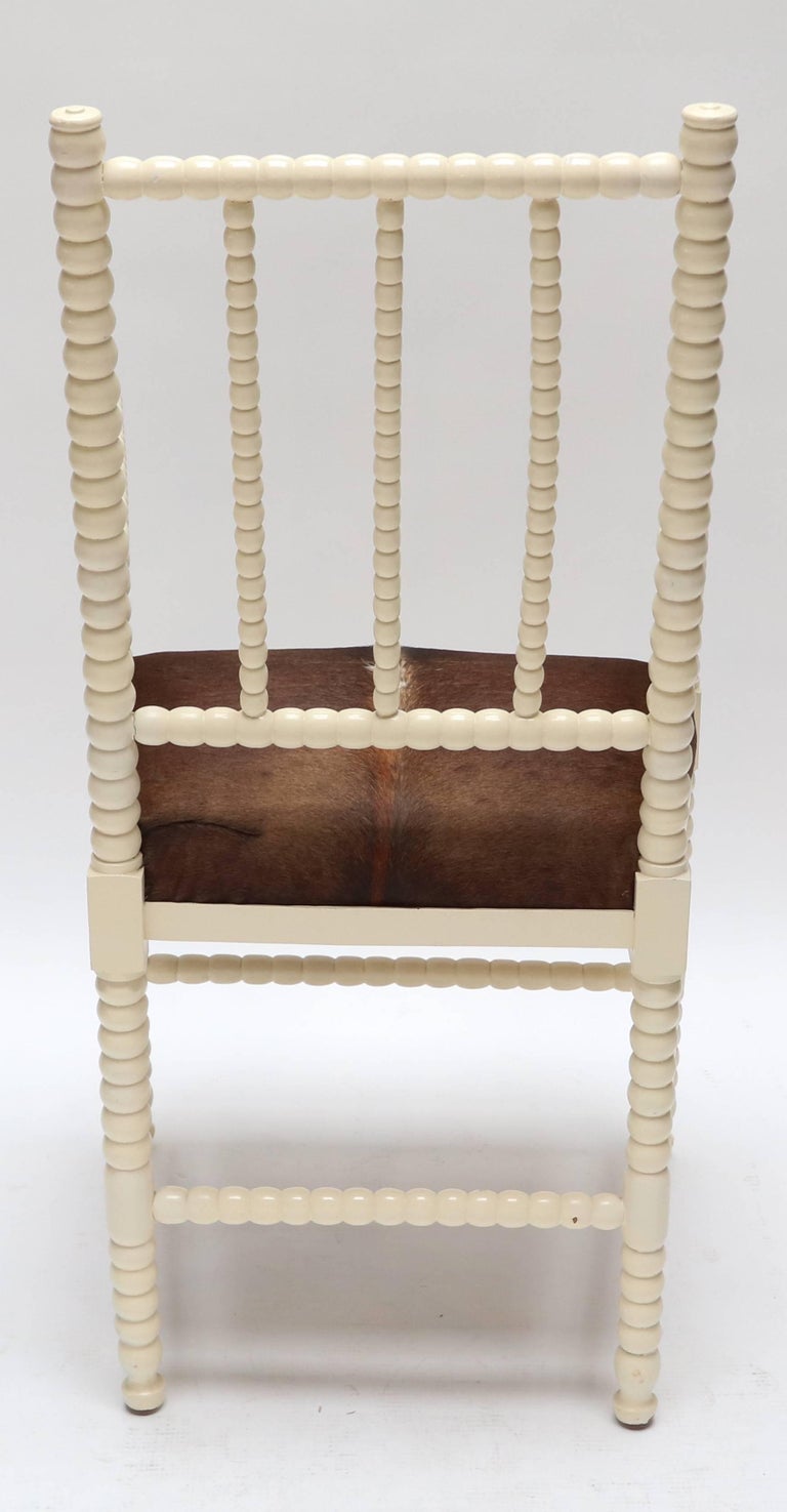 Pair of 1940s Ivory Spool Armchairs in Brown Cow Hide For Sale at 1stDibs