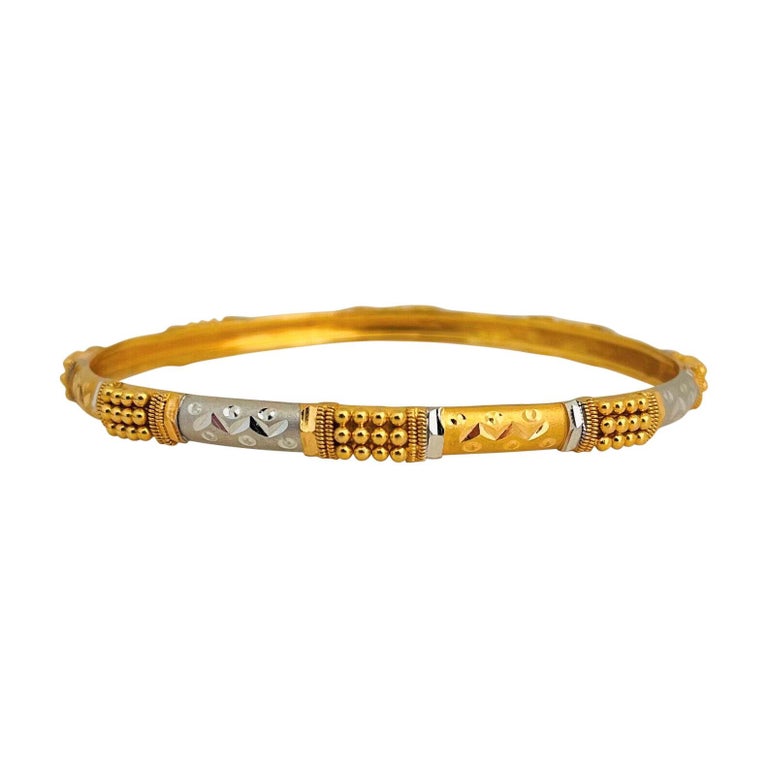 Pair of 22 Karat Yellow Gold and Rhodium Diamond Cut Bangle Bracelets ...
