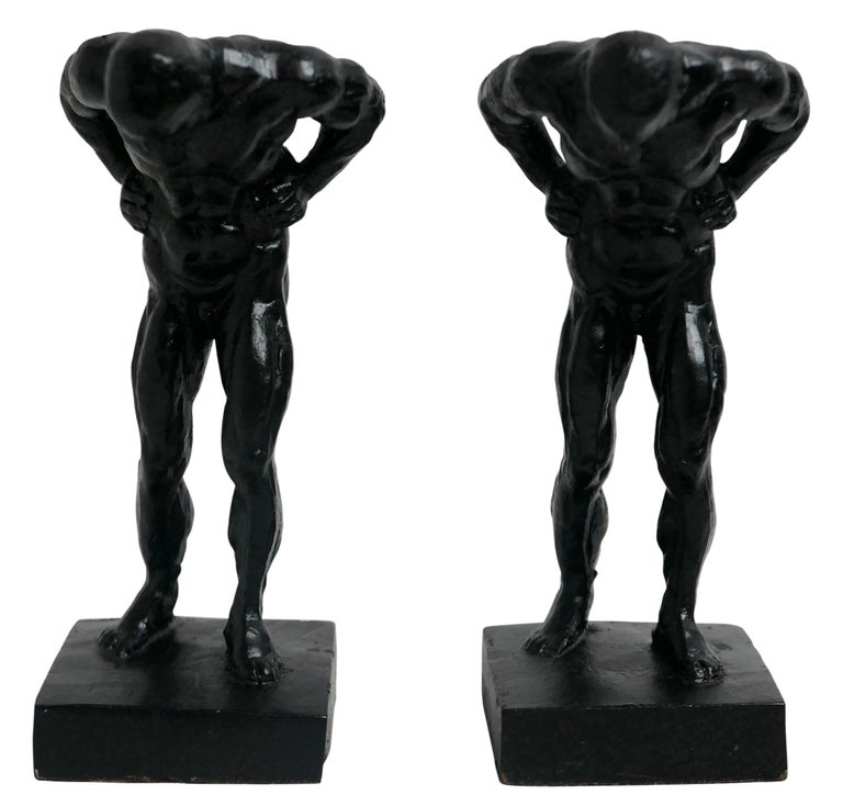 Pair of Cast Iron Muscular Male Figural Bookends at 1stDibs