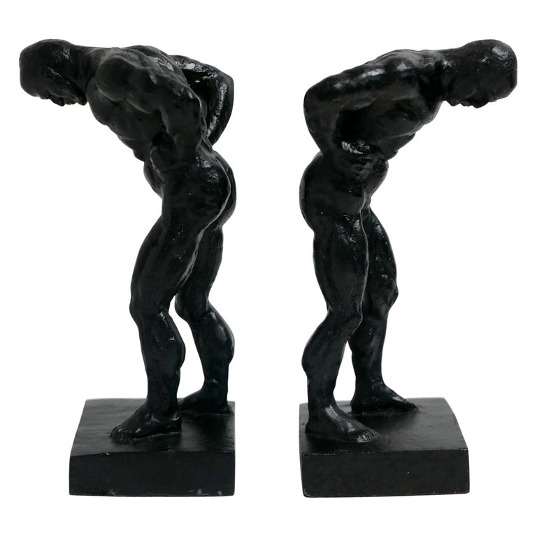 Pair of Cast Iron Muscular Male Figural Bookends at 1stDibs
