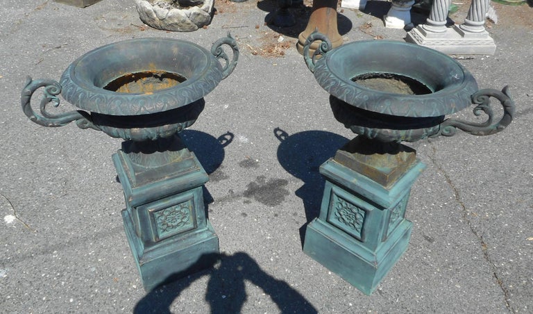 Pair of Cast Iron Urns on Pedestal Bases at 1stDibs