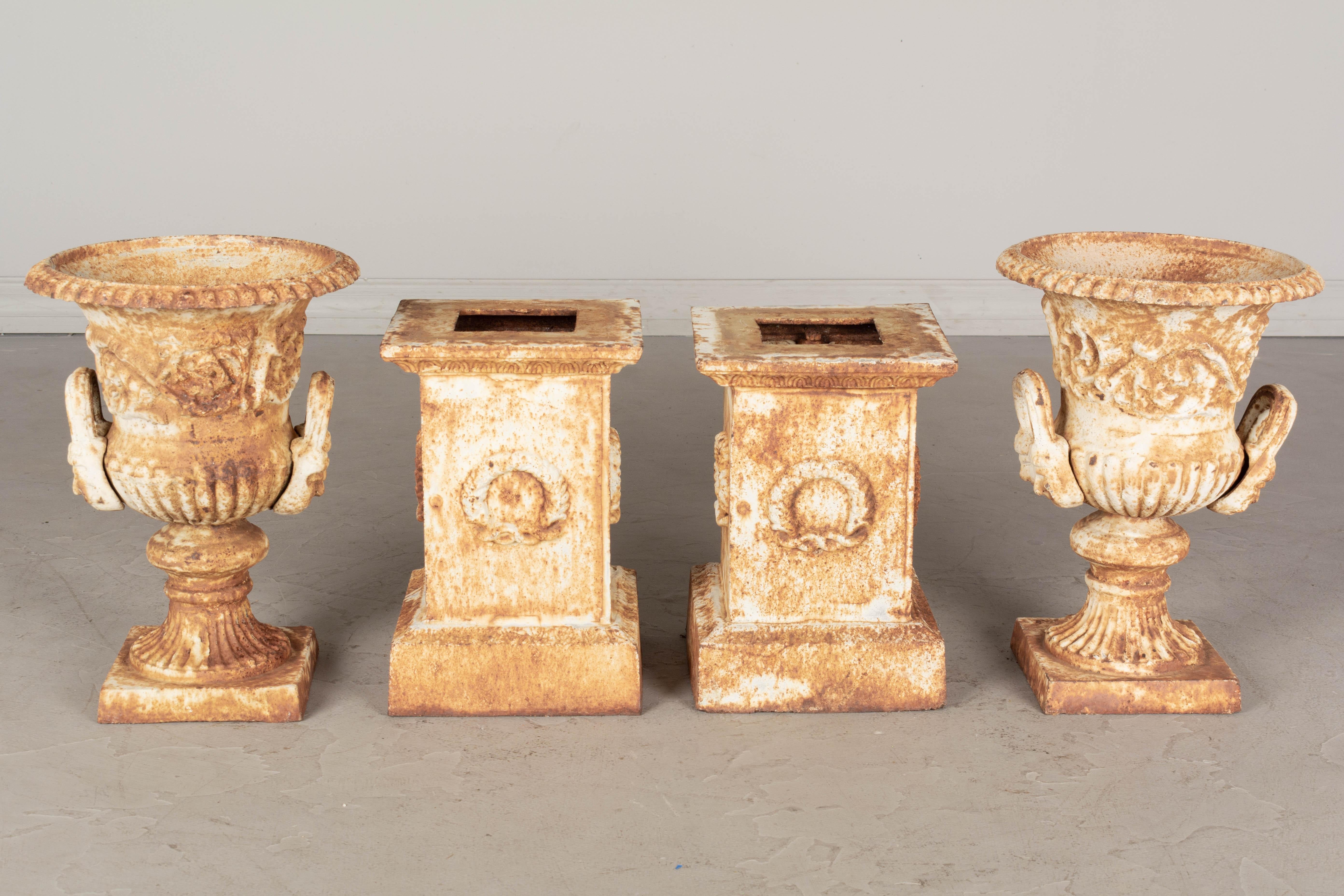 Pair of French Cast Iron Garden Urns on Plinth Base at 1stDibs