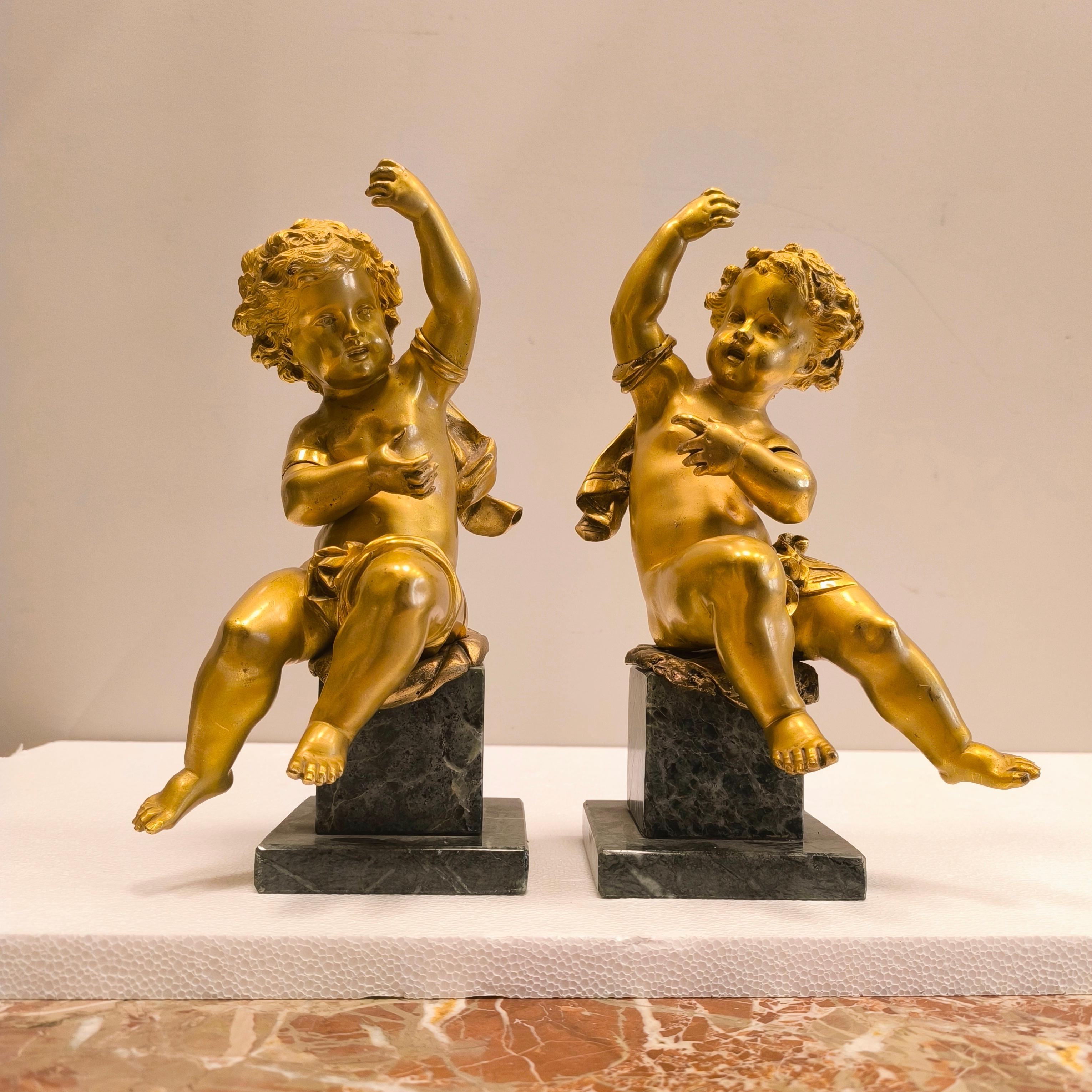 Pair of French putti in gilt and chiseled bronze on a green marble base ...