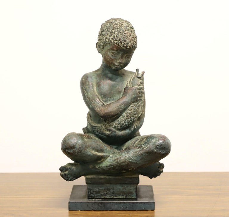 Patinated Bronze Seated Boy Holding Fish Sculpture For Sale at 1stDibs