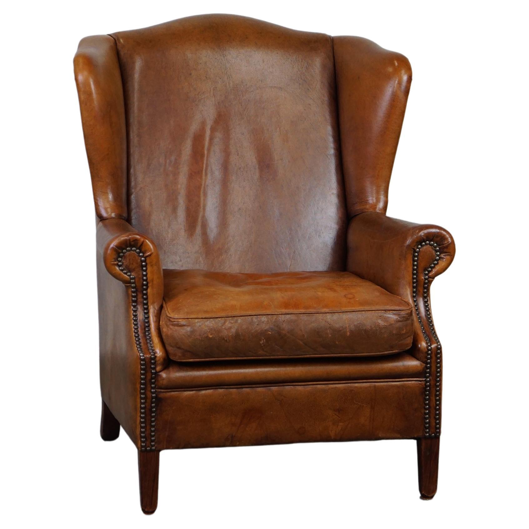 Positively lived-in sheepskin leather wing chair with pleasant seating ...