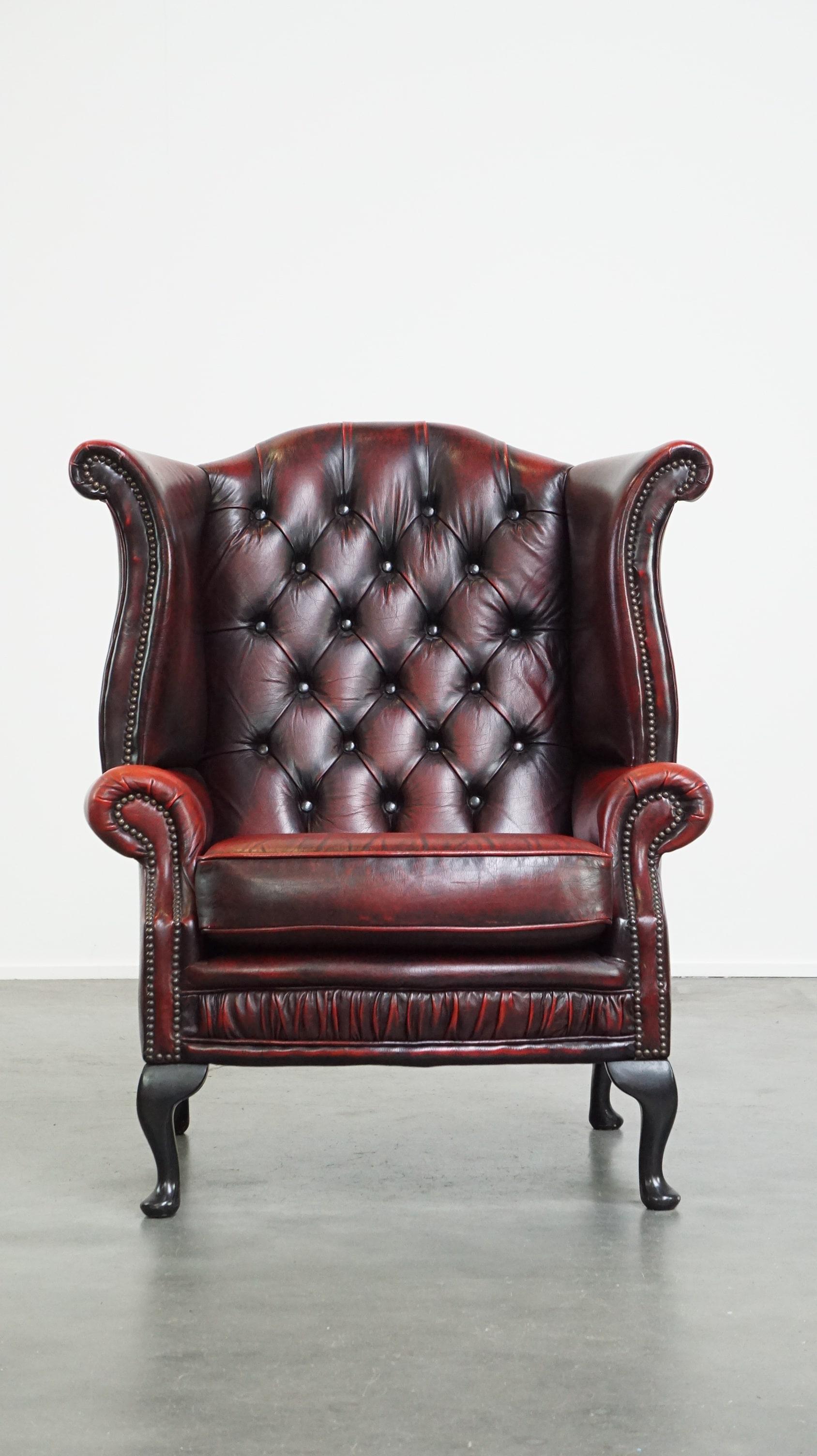 Red English Chesterfield wing chair made of cowhide leather with Queen ...