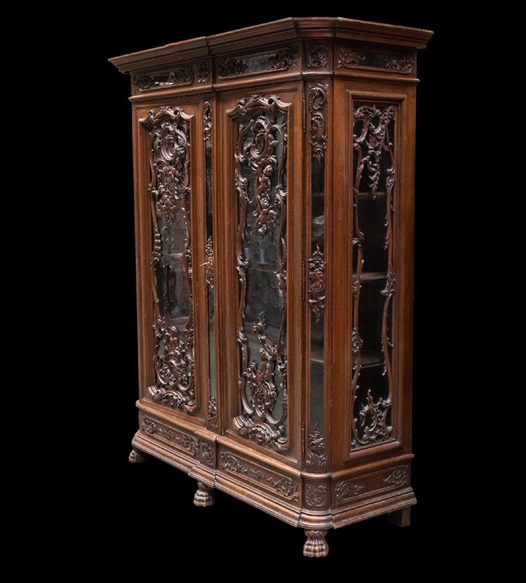 Richly carved 19th century cabinet with claw feet. For Sale at 1stDibs