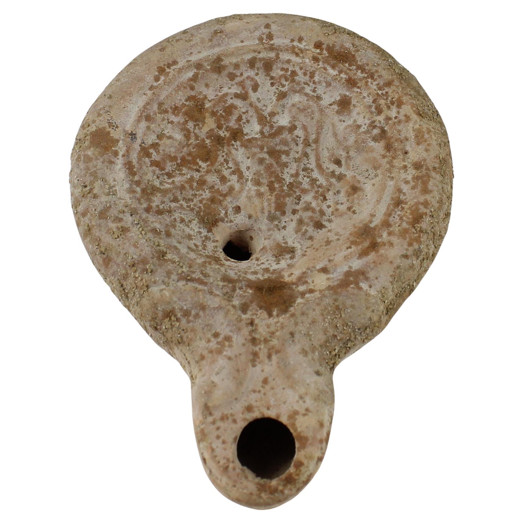 Roman oil lamp with leaves and fruit For Sale at 1stDibs