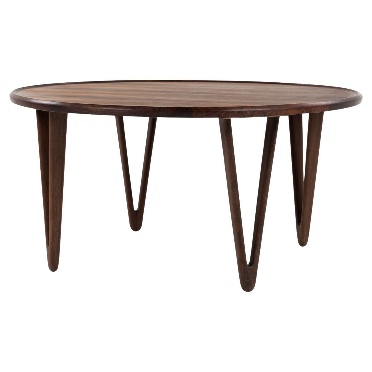 Round coffee table in rosewood with a beveled edge and V-shaped legs ...