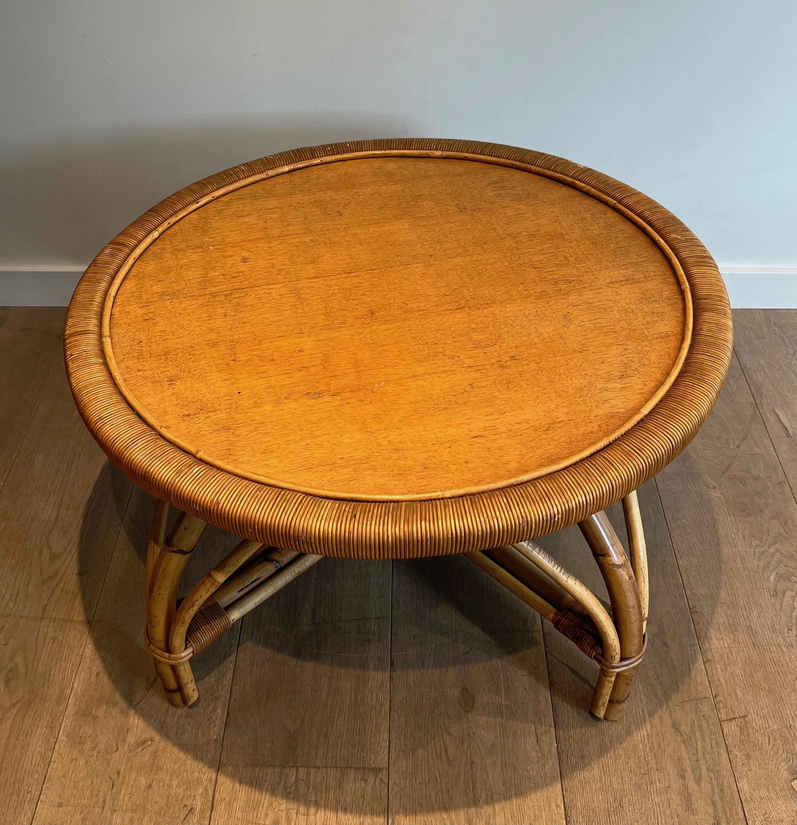 Round rattan coffee table with a wooden top attributed to Audoux Minet ...