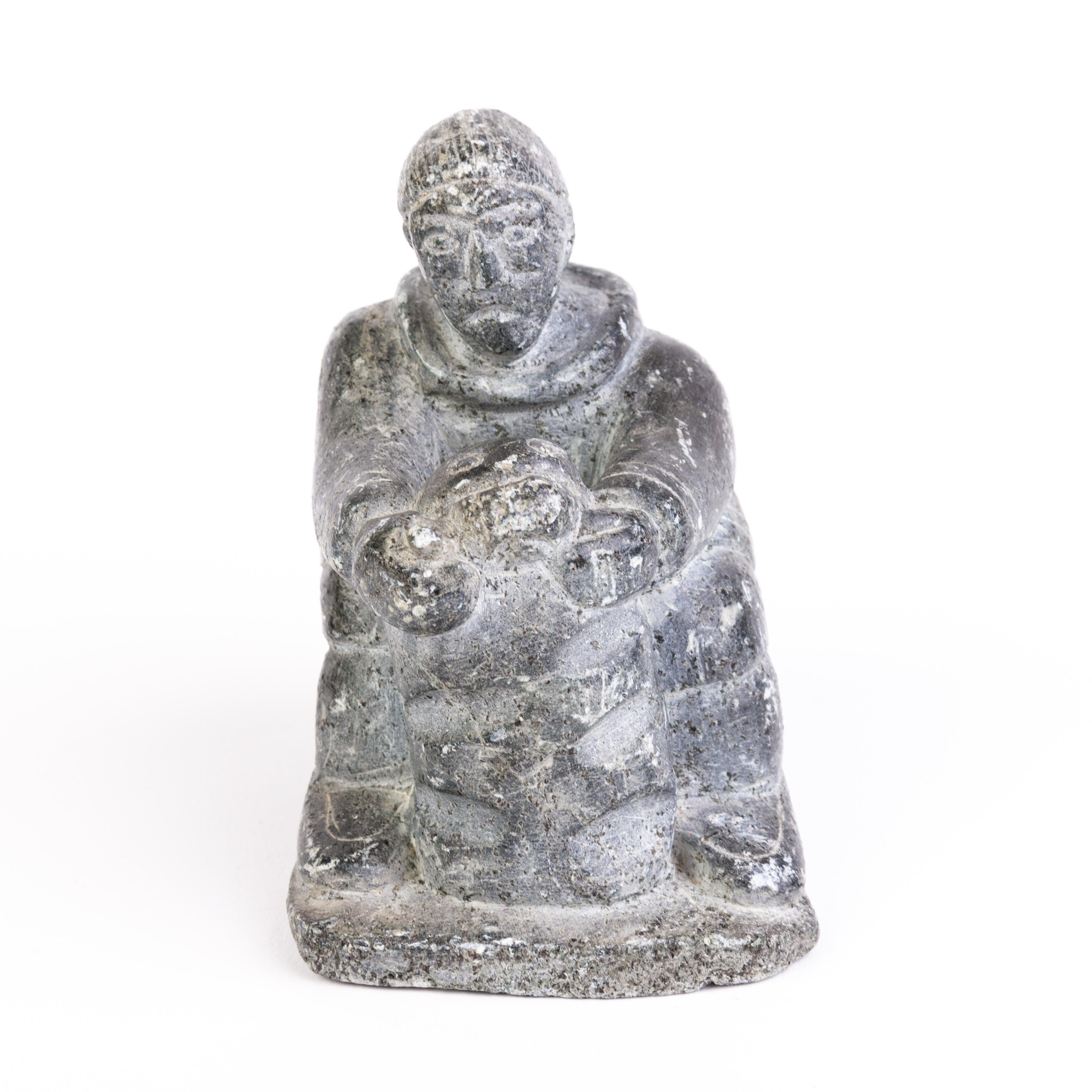 Signed Canadian Inuit Man with Seal Stone Sculpture For Sale at 1stDibs