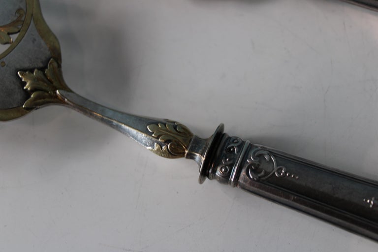 Silver and gold metal serving cutlery in their box For Sale at 1stDibs