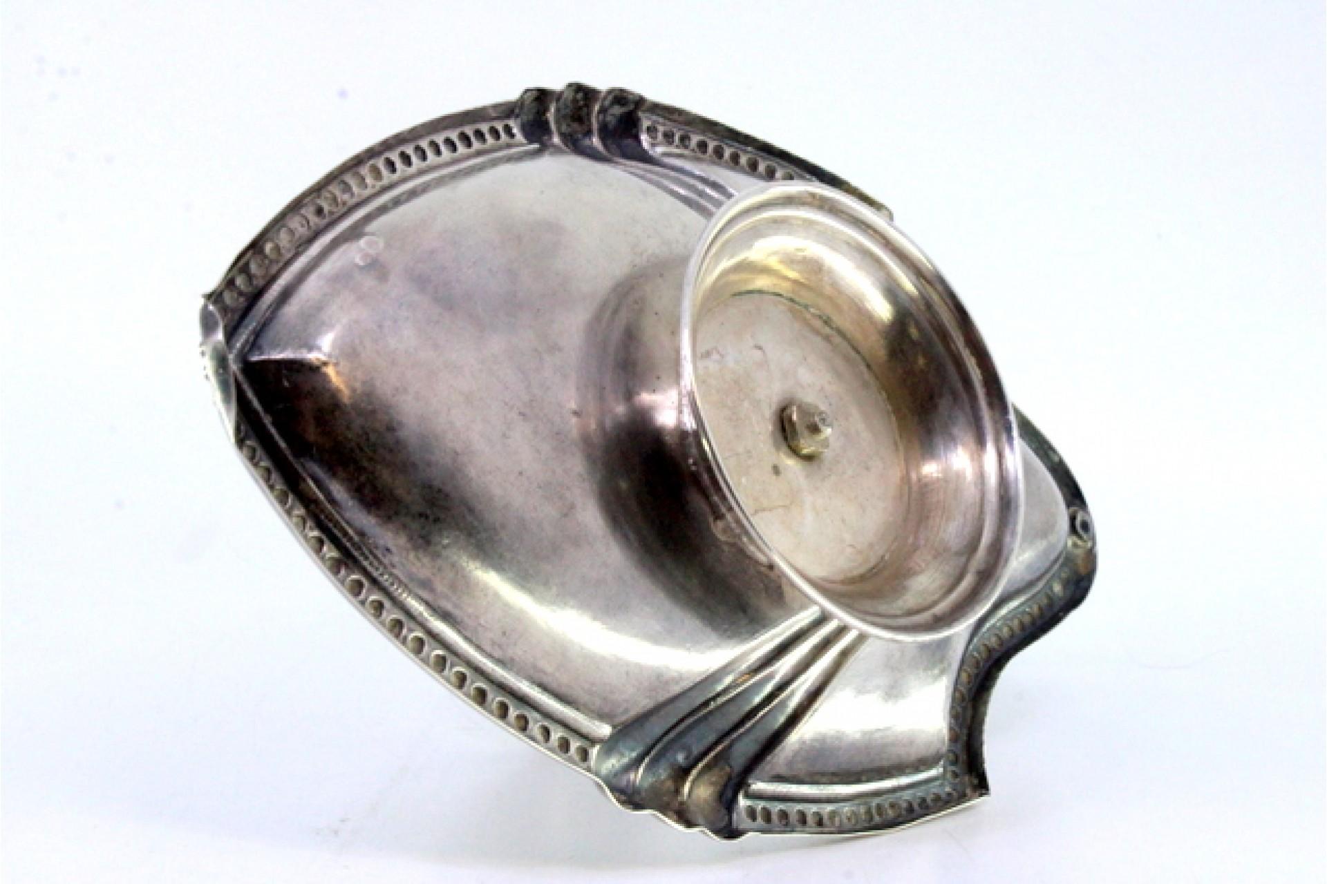 Silver paddle with pearly friezes and leaf-shaped reliefs supporting ...