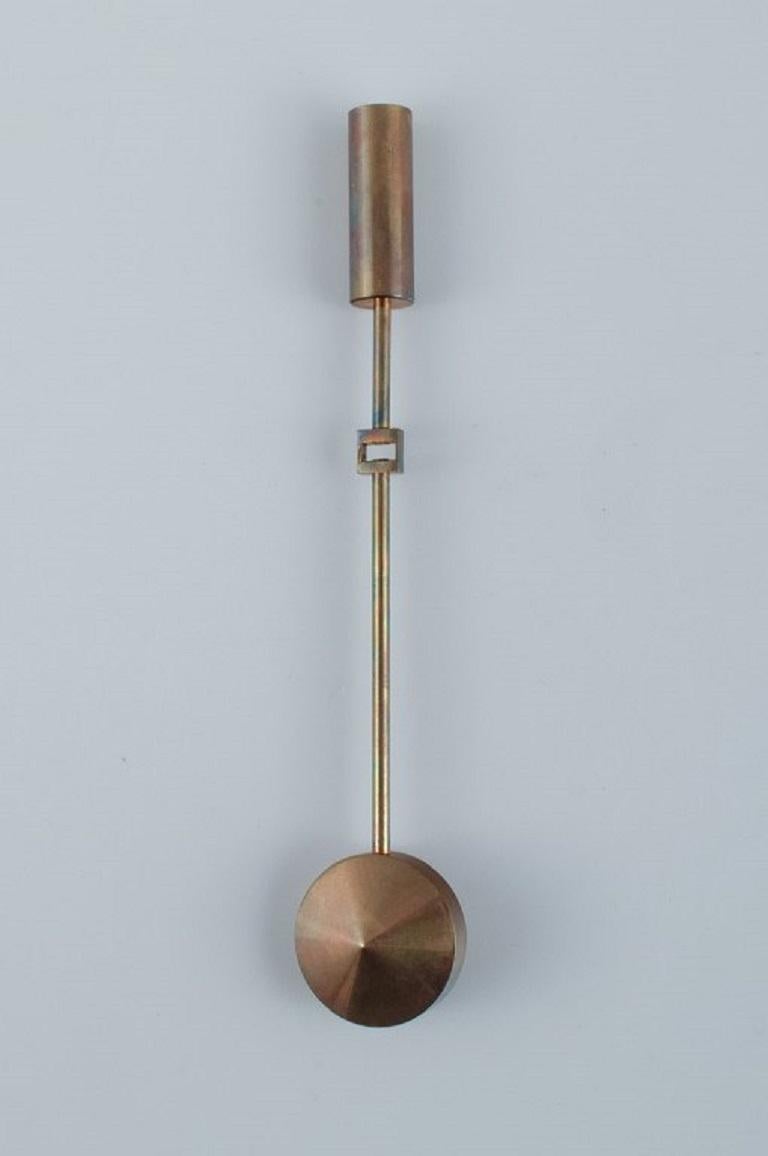 Skultuna, Sweden, a pair of brass candlesticks for wall hanging. For ...