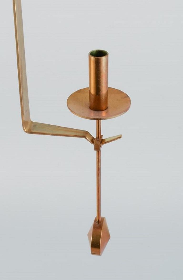 Skultuna, Sweden. A pair of brass candlesticks for wall hanging. For ...